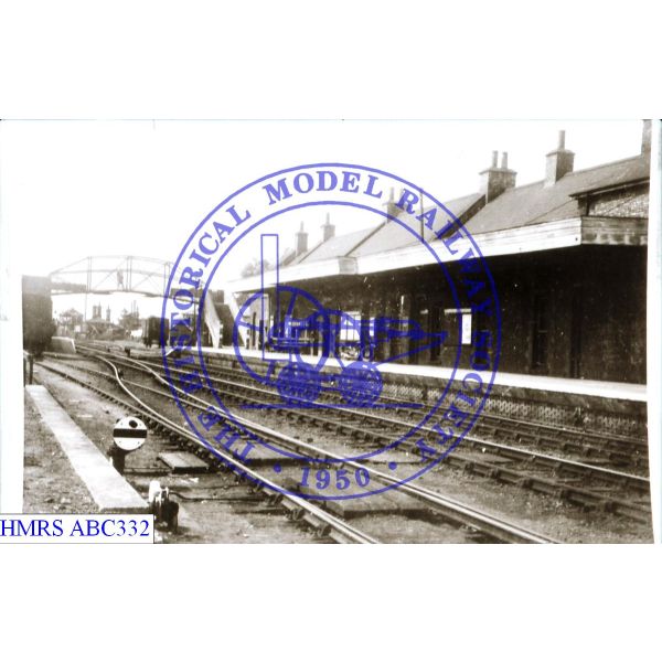 [ABC332] Brandon station, buildings in shadow right, siding exit signal foreground Shows very ...