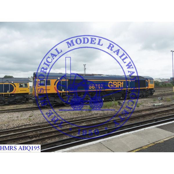 [ABQ195] 66767 in GB Railfreight blue and orange livery. Angled side ...
